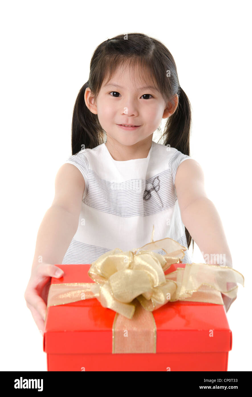 Little Asian girl arms out holding a beautiful wrapped present. Focus ...