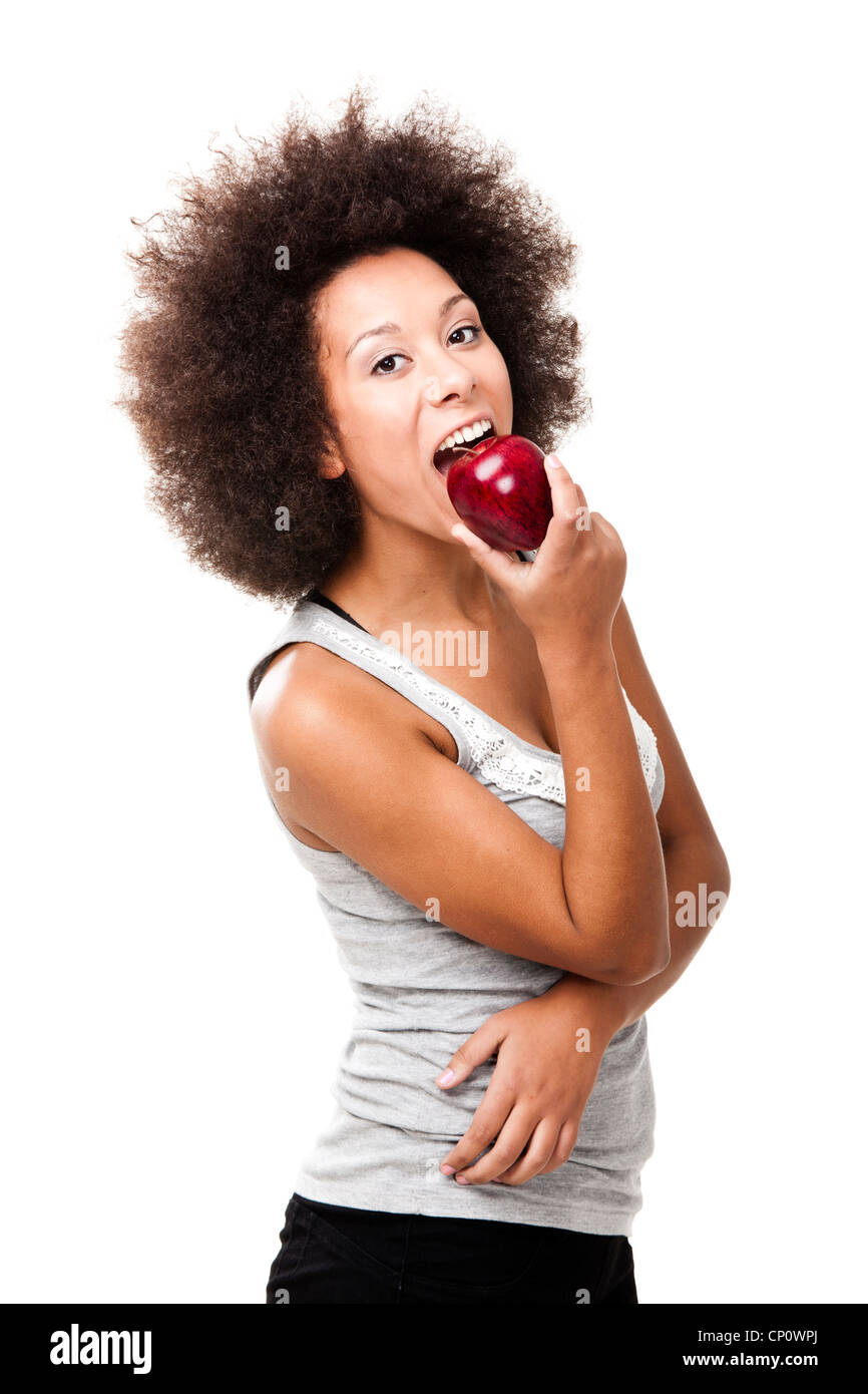 African American young woman holding and eating an apple Stock Photo ...