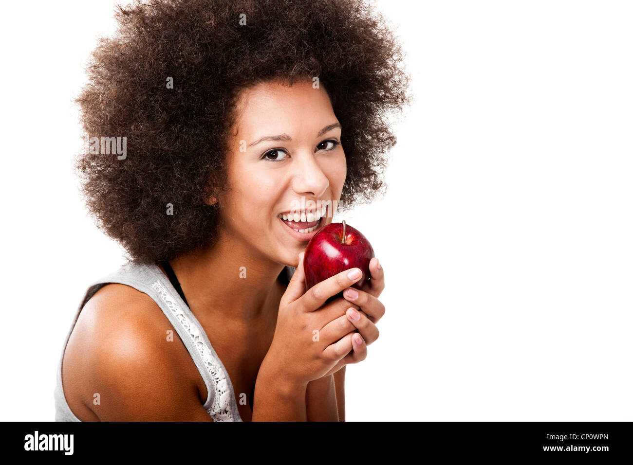 African American young woman holding and eating an apple Stock Photo ...