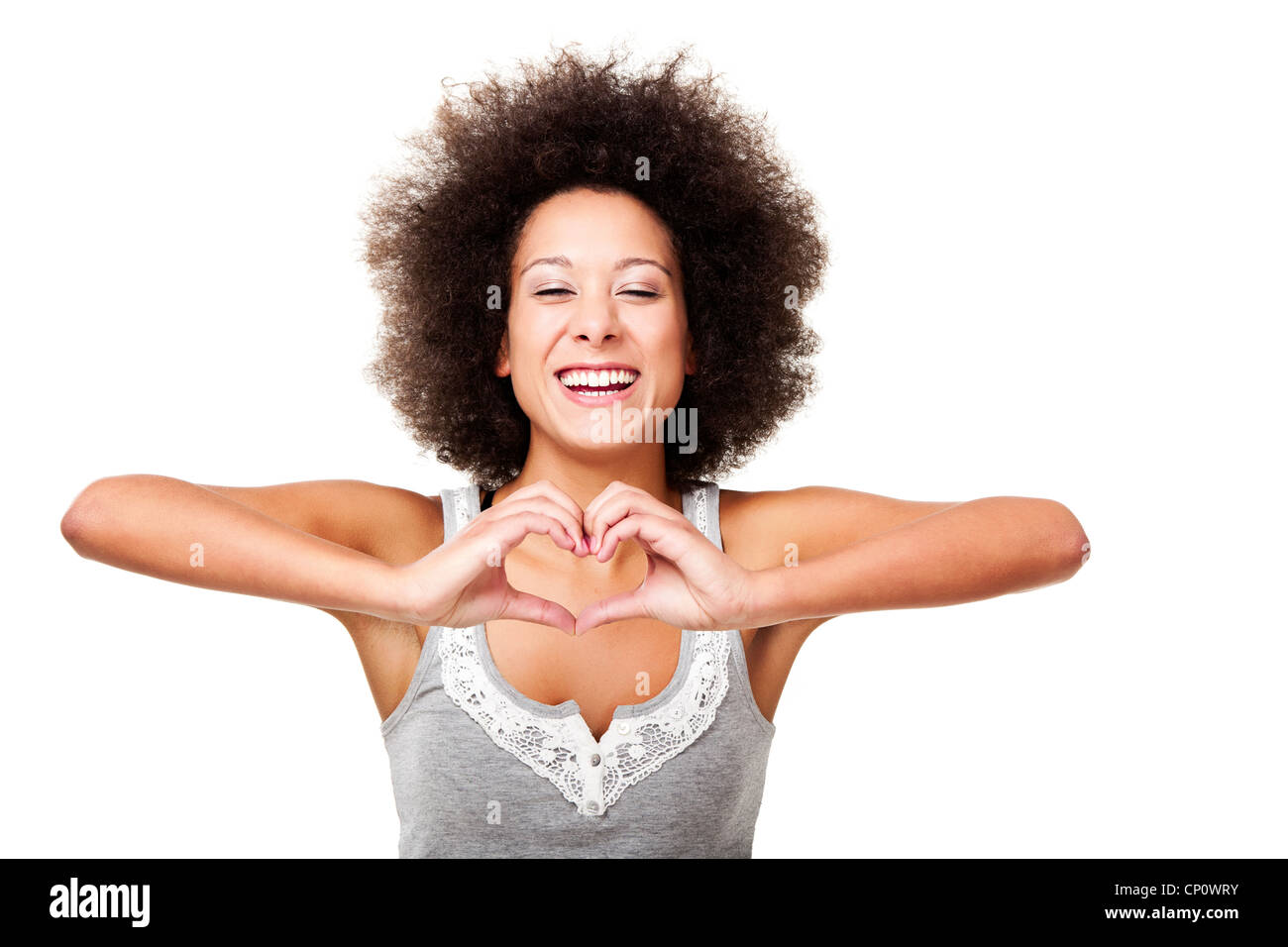 Beautiful young woman making a heart with hands, isolated on white ...