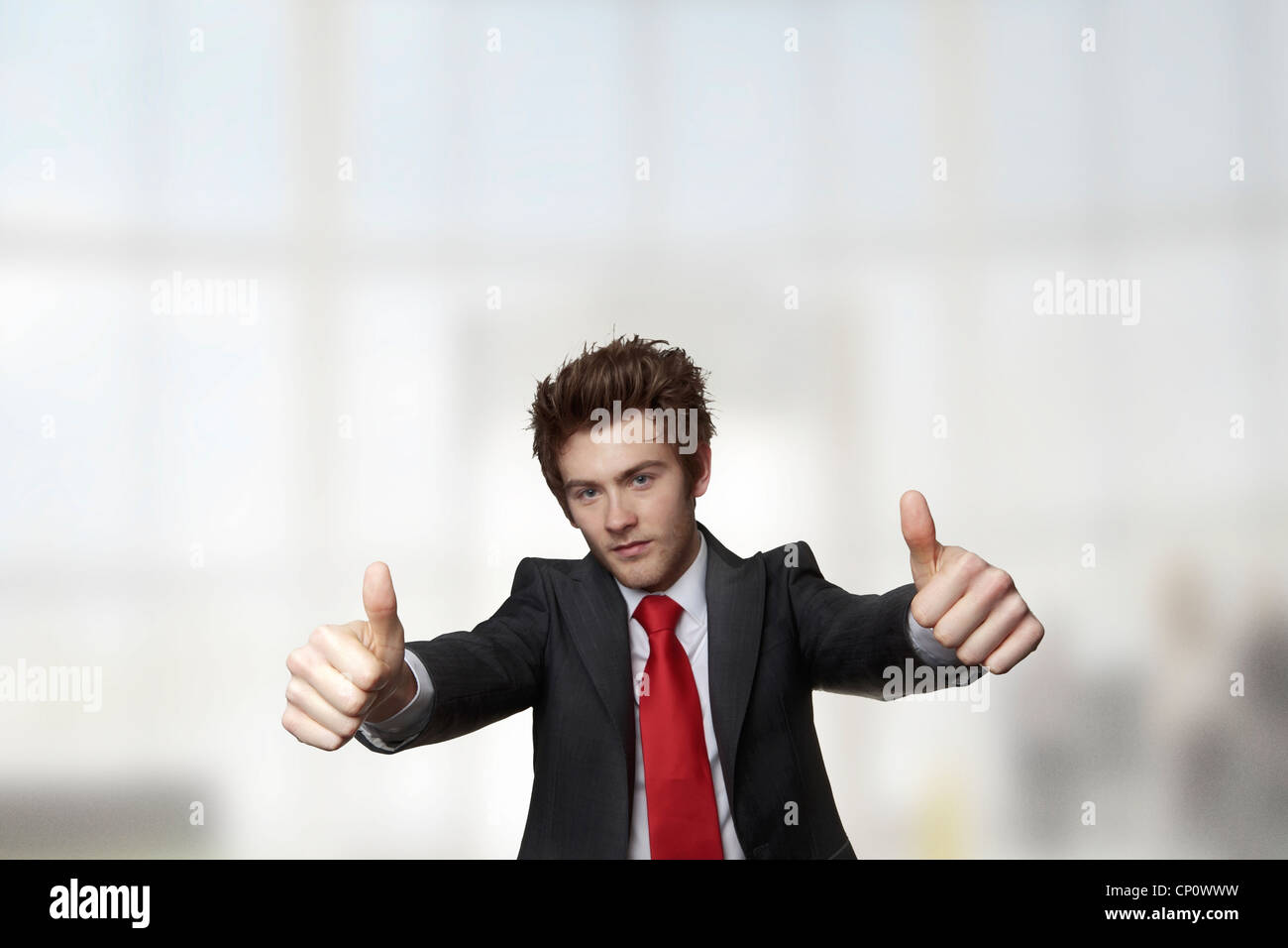 young businessman very happy with his thumbs up Stock Photo - Alamy