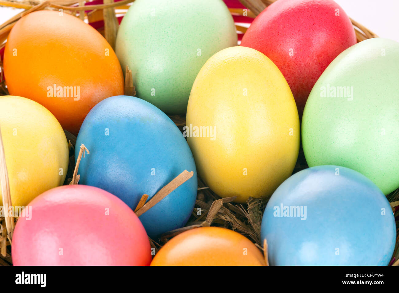 eastern eggs in different colours in a basket with a rabbit Stock Photo ...