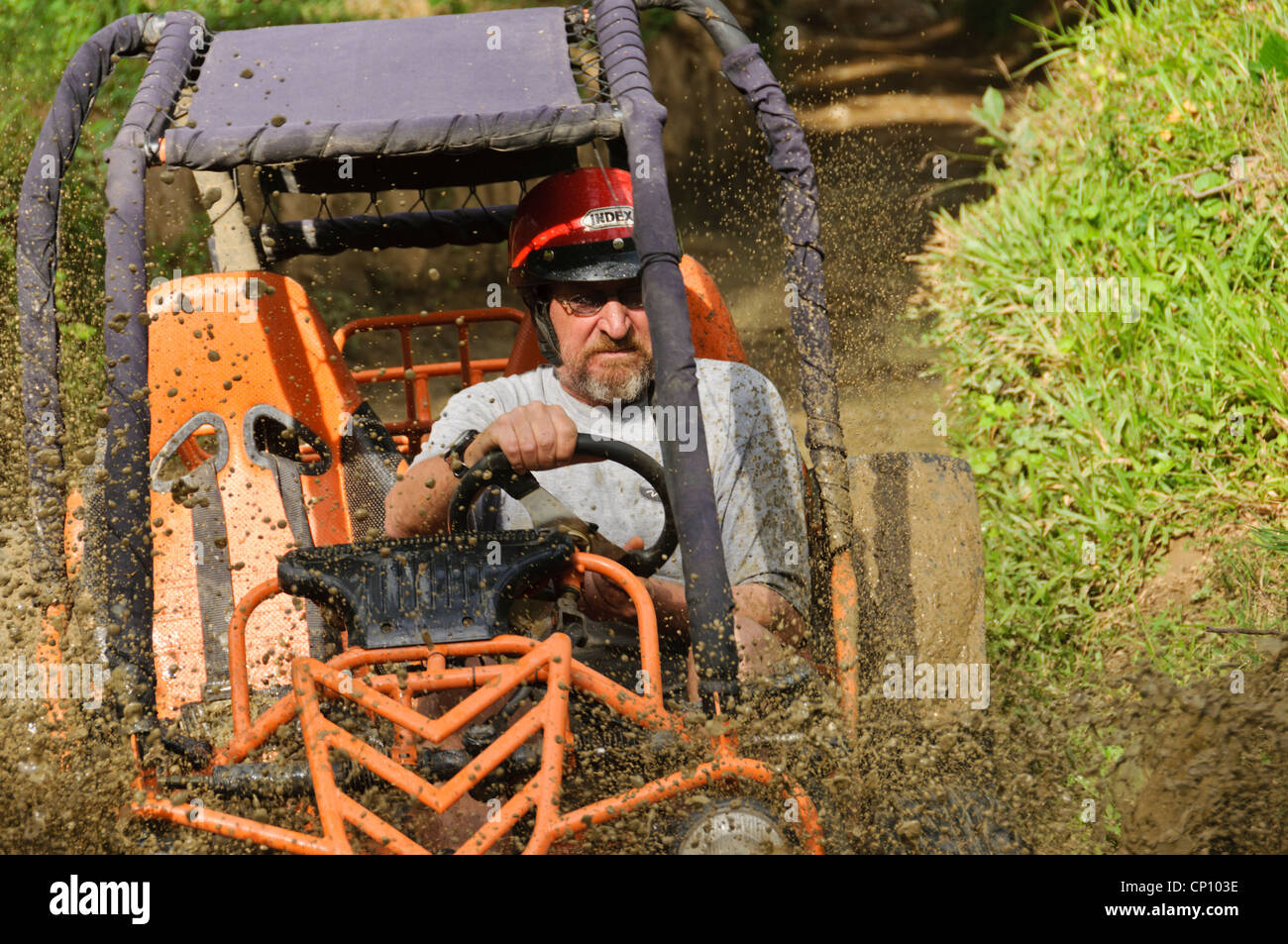Caucasian man 50-60 years racing off-road buggy muddy race track Puerto ...