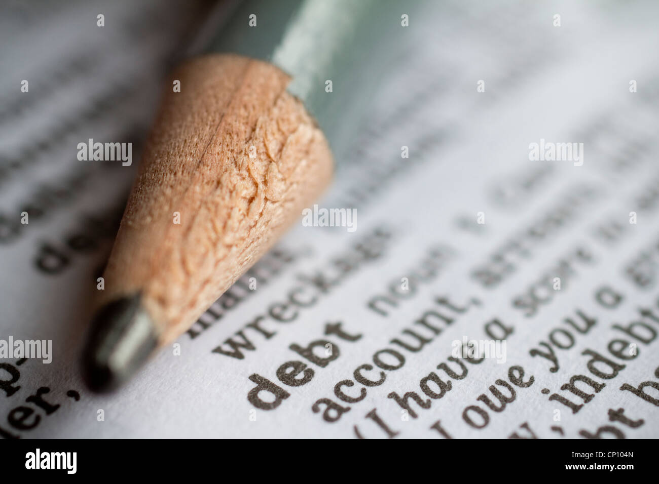 The word "debt" shown in a dictionary with a pencil, symbolising ...