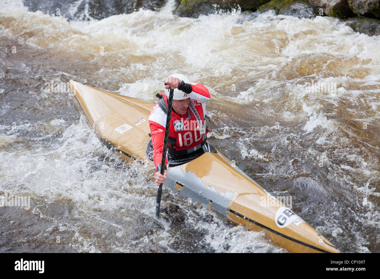 a man with a single paddle canoe, white water kayaking in bala north ...