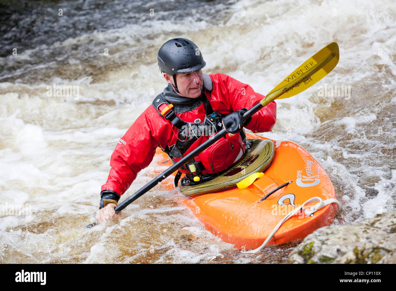a man white water kayaking in bala north wales, snowdonia, canolfan on ...