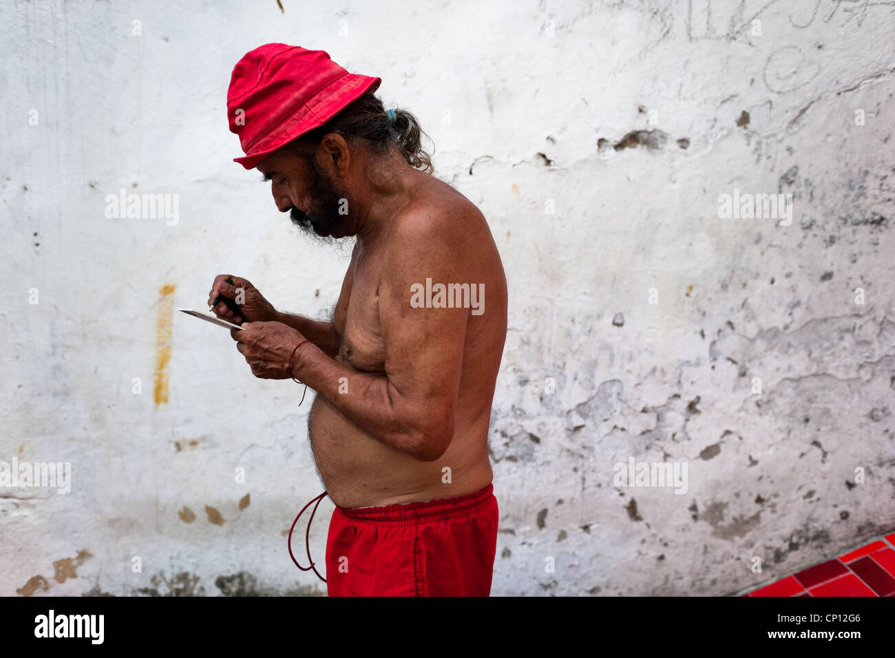 Jorge Selarón paints a picture in front of his house on Selaron's ...