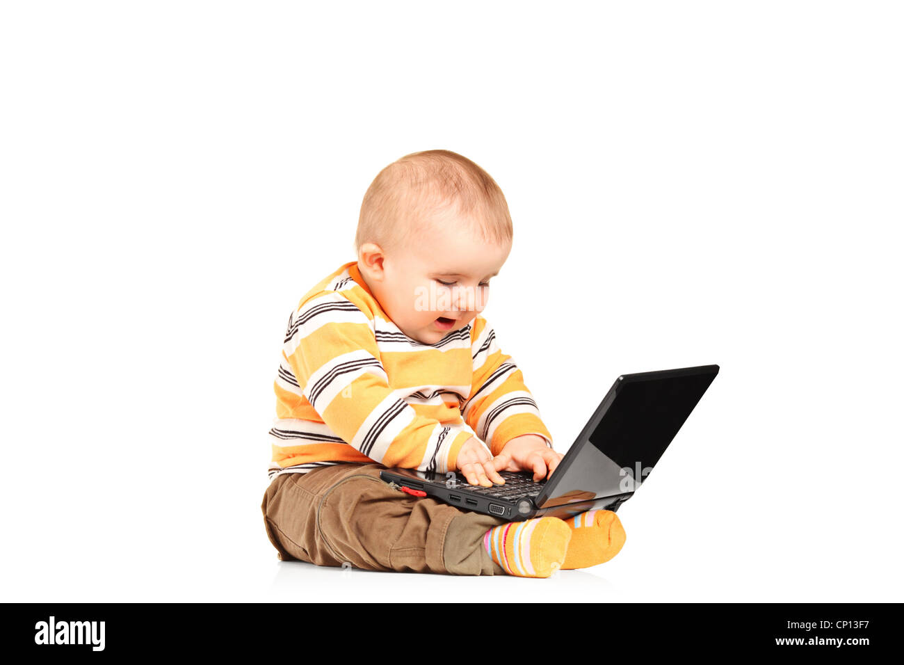 A studio shot of baby boy working on a laptop isolated on white ...