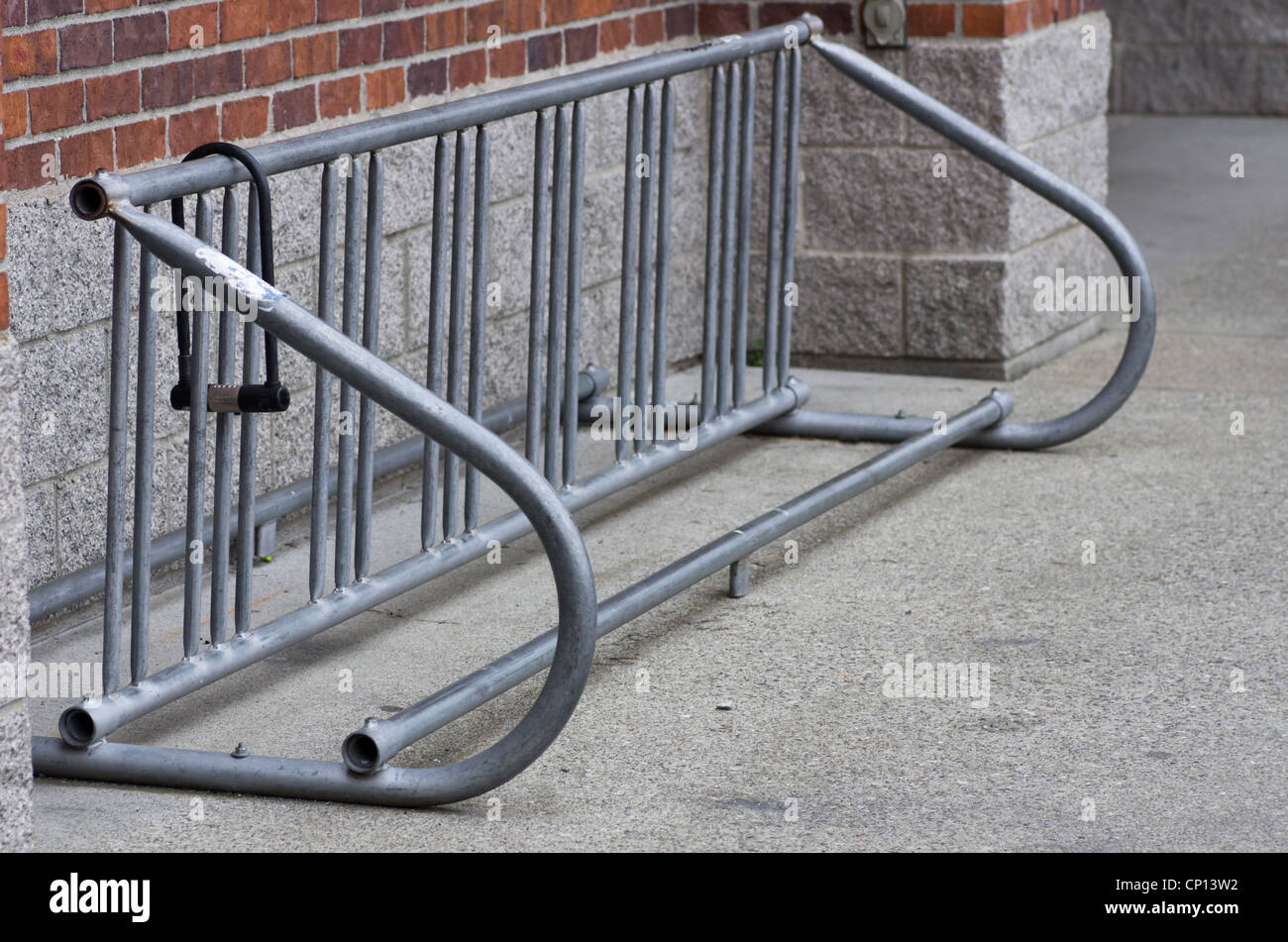 An empty bicycle rack with abandoned bike lock Stock Photo - Alamy