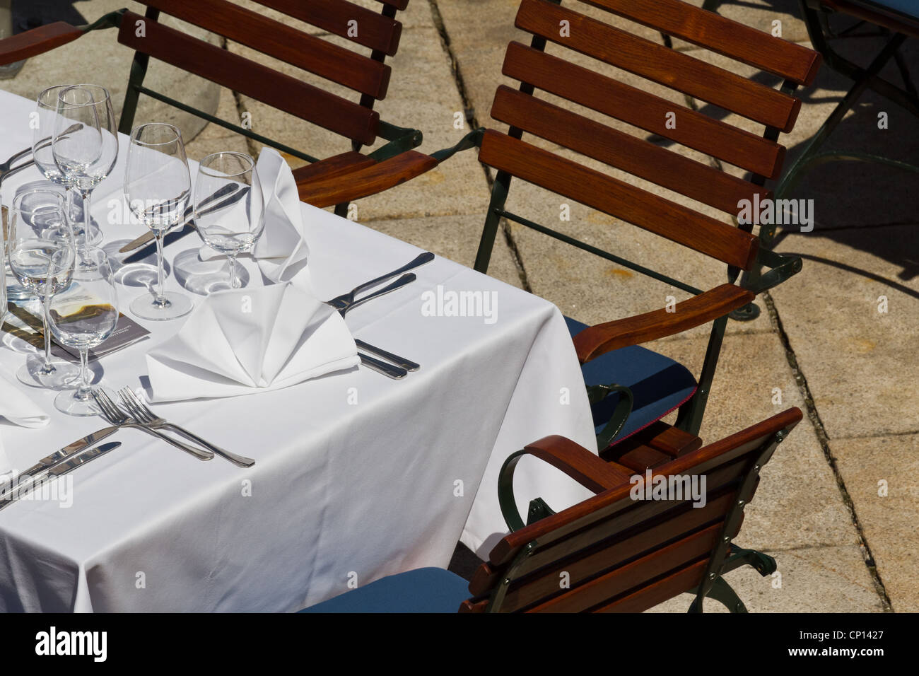 A table in a restaurant with covers on a terrace Stock Photo - Alamy