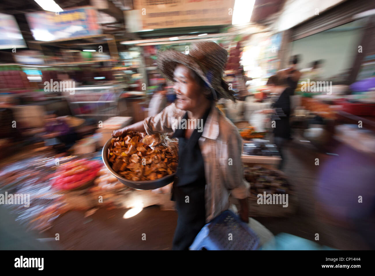 Panned motion of a women holding a basket at an indoor market in Siem ...