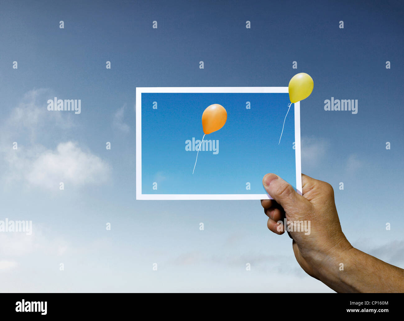 Hand Holding Photograph with Balloons escaping Stock Photo - Alamy
