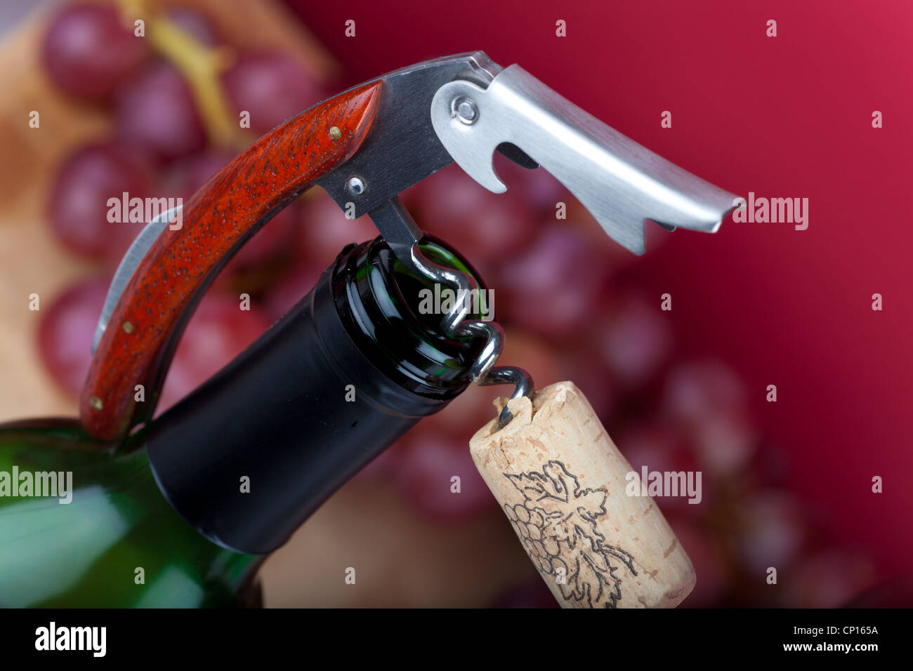 A corkscrew with cork on the top of bottleneck Stock Photo - Alamy
