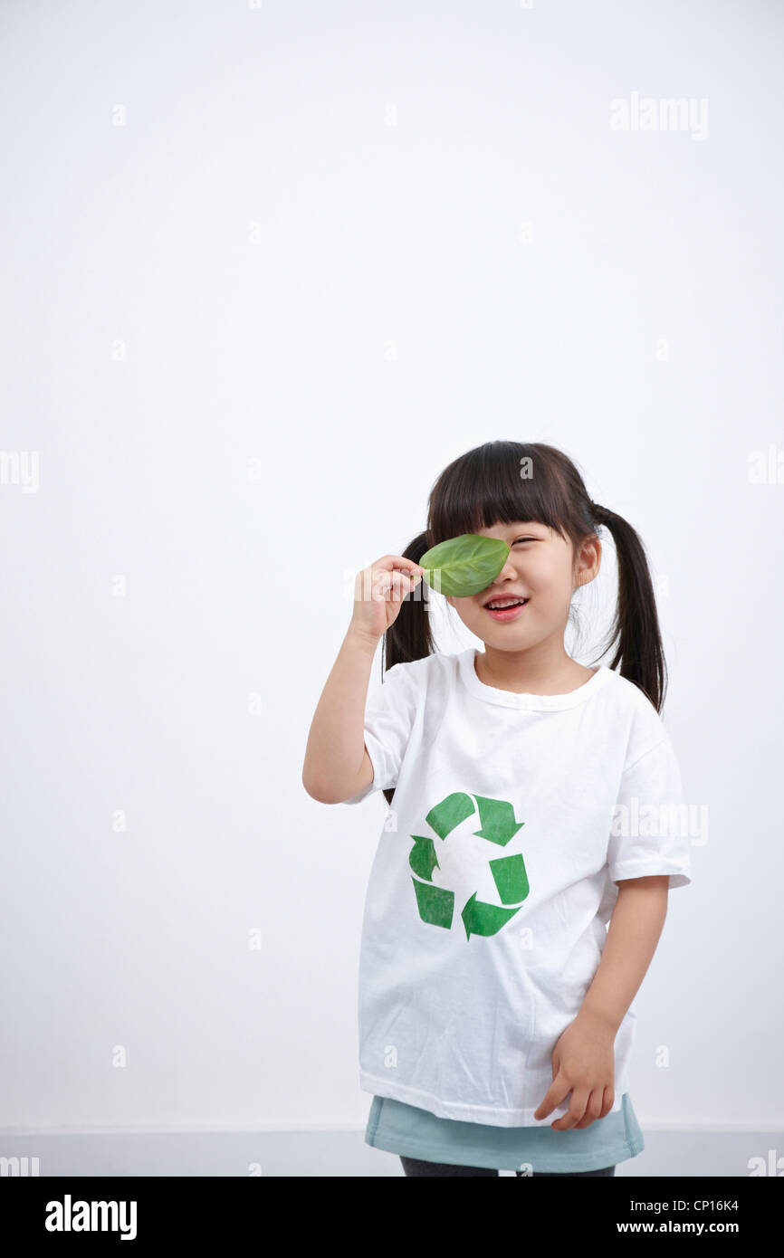 A girl wearing recycling shirt with green leaf Stock Photo - Alamy