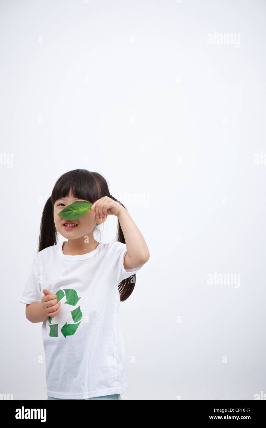 A girl wearing recycling shirt with green leaf Stock Photo - Alamy