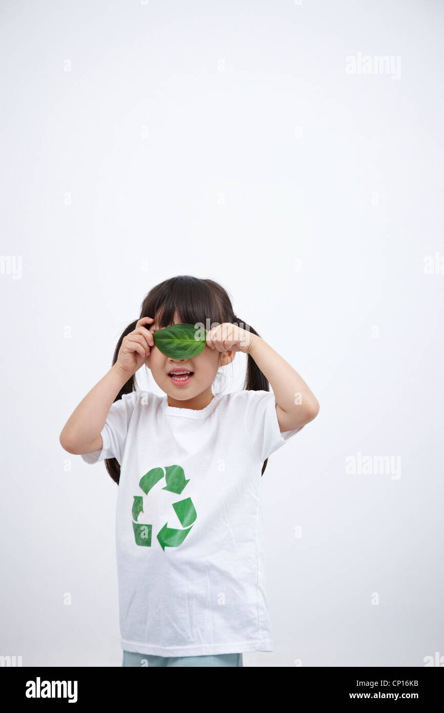 A girl wearing recycling shirt with green leaf Stock Photo - Alamy