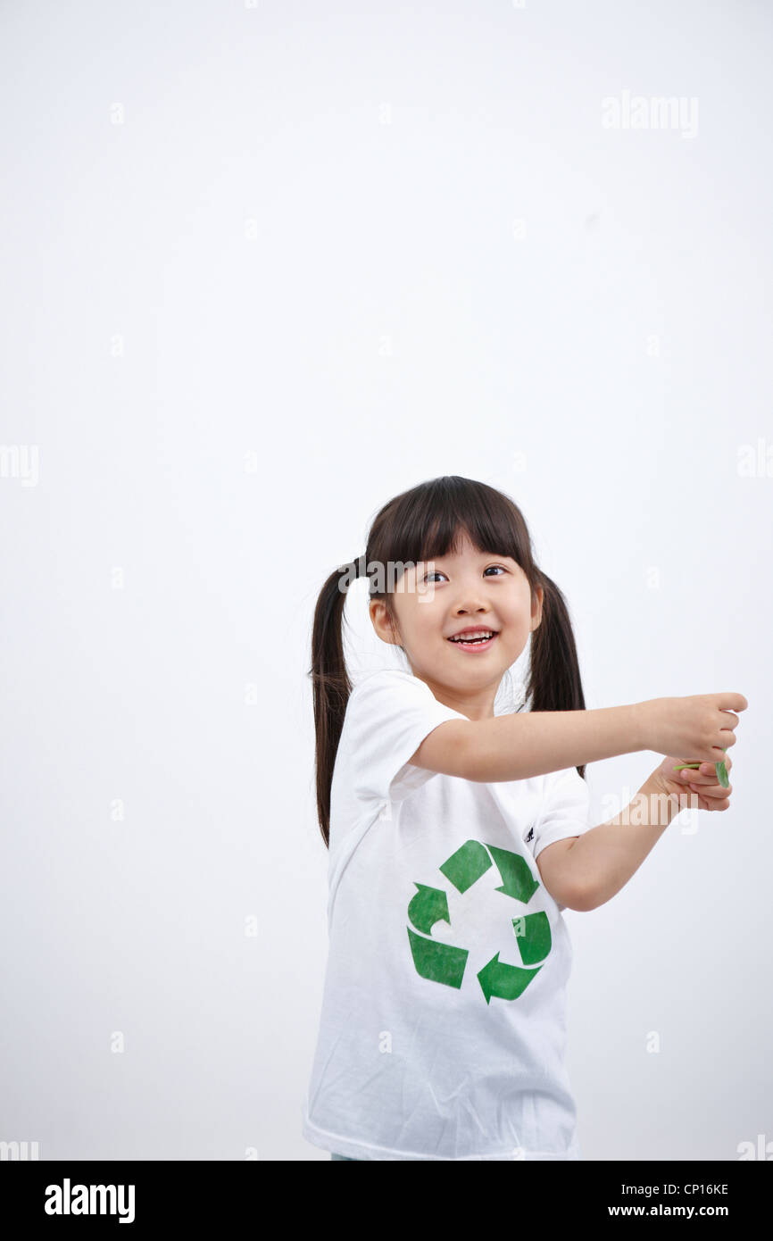 A girl wearing recycling shirt with green leaf Stock Photo - Alamy