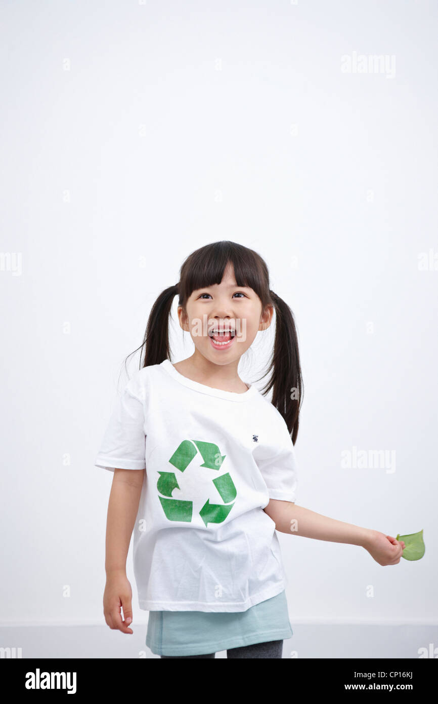 A girl wearing recycling shirt with green leaf Stock Photo - Alamy