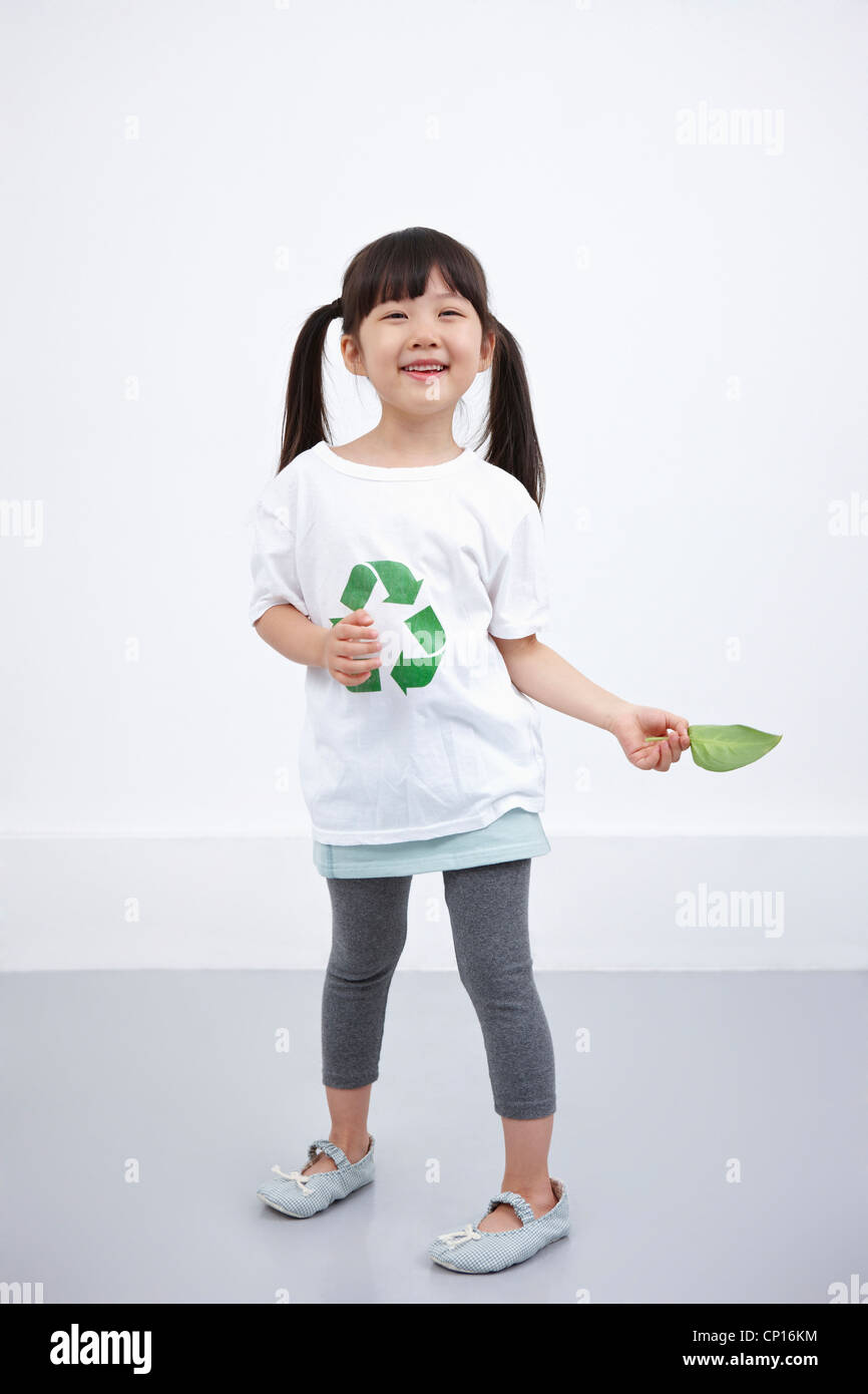 A girl wearing recycling shirt with green leaf Stock Photo - Alamy
