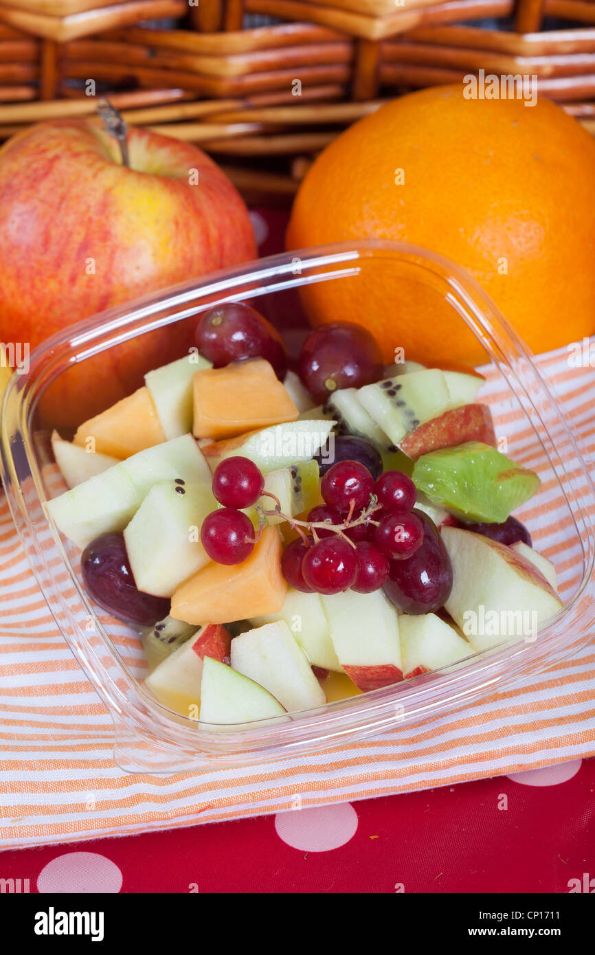Fresh summer fruit salad with ribes, apple, kiwi, grapes and melon ...