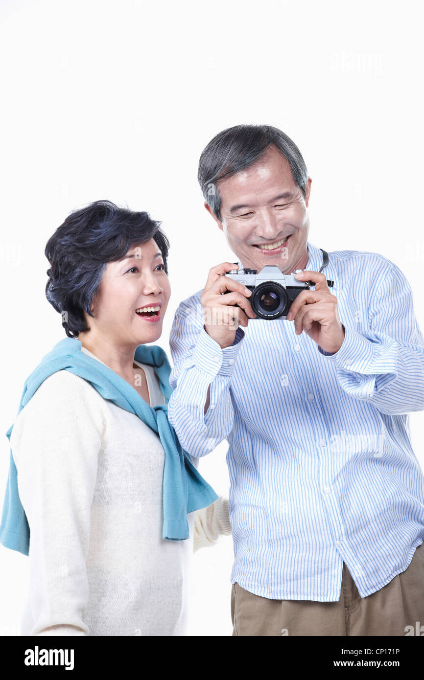 An old couple photographing with camera Stock Photo - Alamy