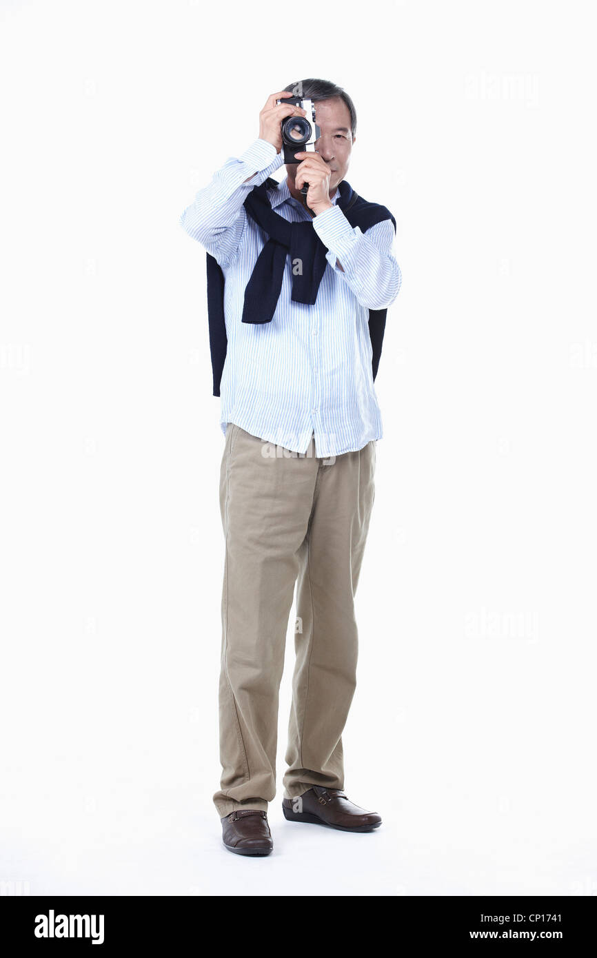 An old man photographing with camera Stock Photo - Alamy