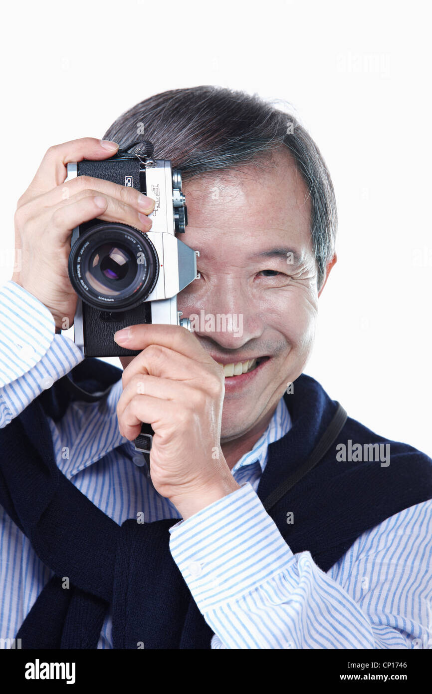 An old man photographing with camera Stock Photo - Alamy