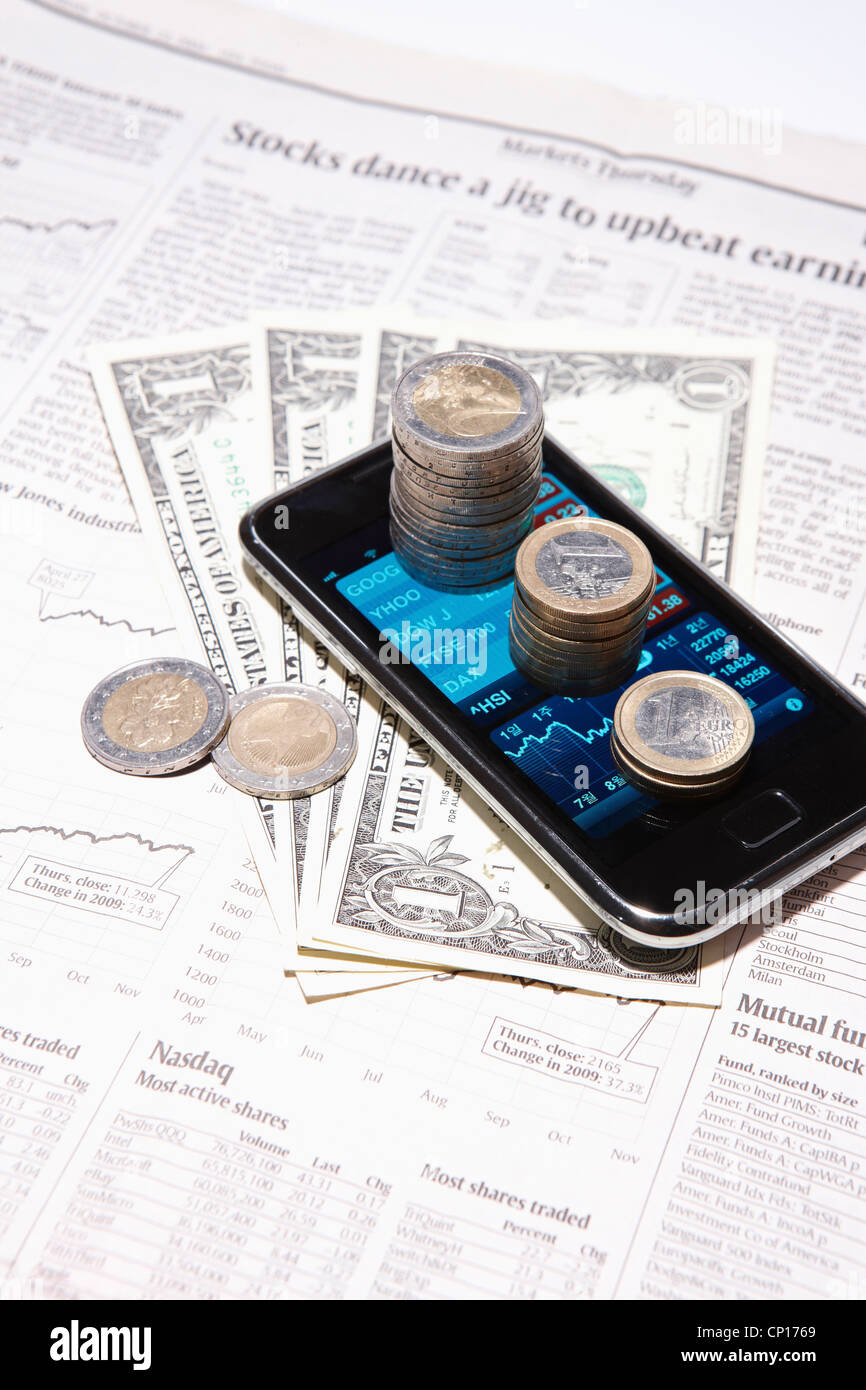 Smartphone and money on the newspaper Stock Photo - Alamy