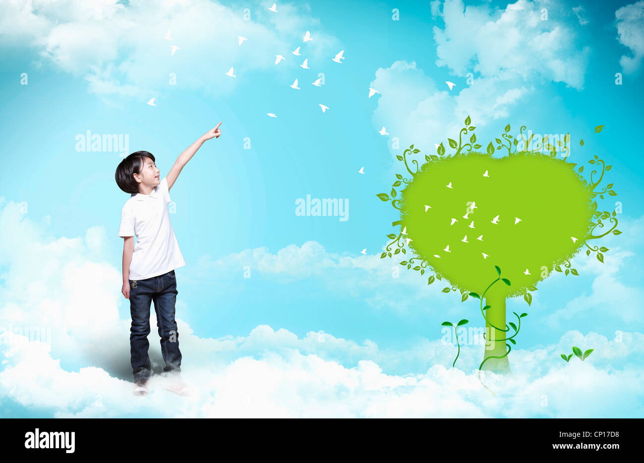 A girl pointing to the bird and a green tree Stock Photo - Alamy