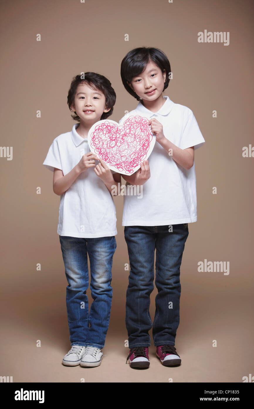 Boy girl holding heart hi-res stock photography and images - Alamy