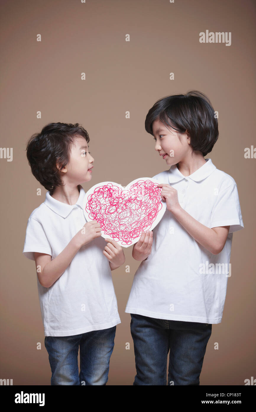 Boy girl holding heart hi-res stock photography and images - Alamy