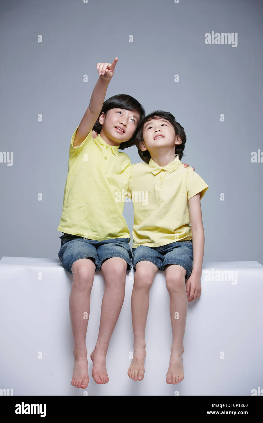 A boy and girl pointing to the sky Stock Photo - Alamy