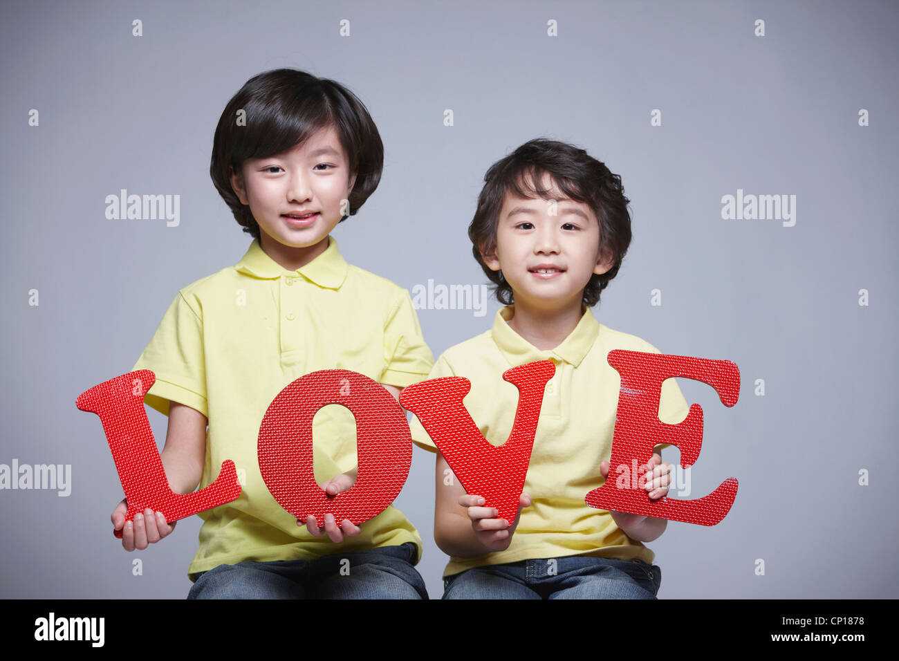 A boy and girl with red LOVE Stock Photo - Alamy