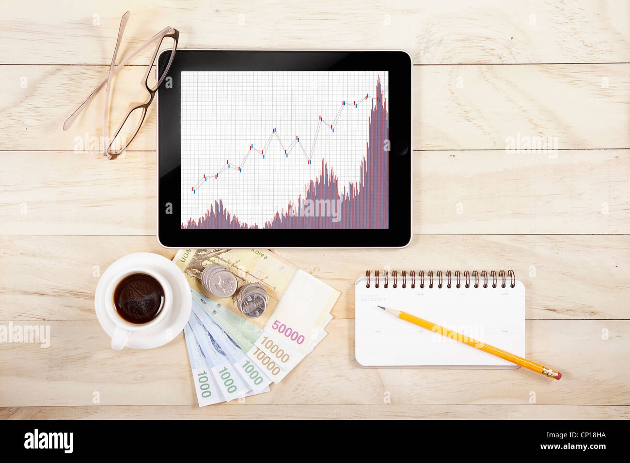 A tablet PC showing the chart on the desk Stock Photo - Alamy