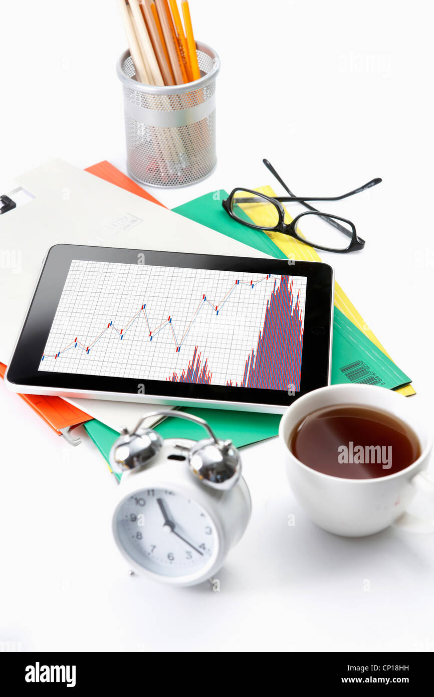 A tablet PC showing the chart on the desk Stock Photo - Alamy