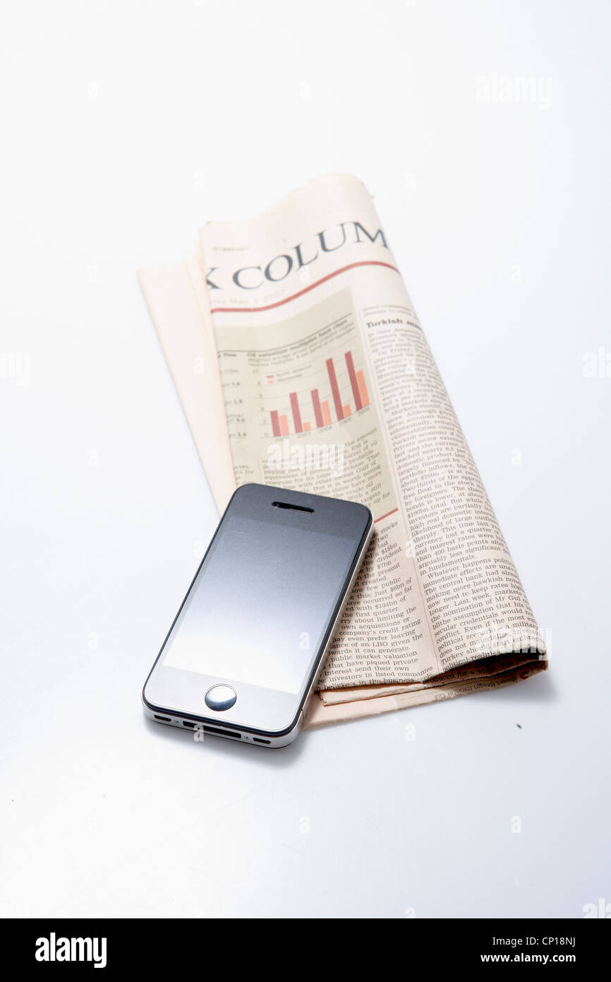 A smart phone and the newspaper Stock Photo - Alamy