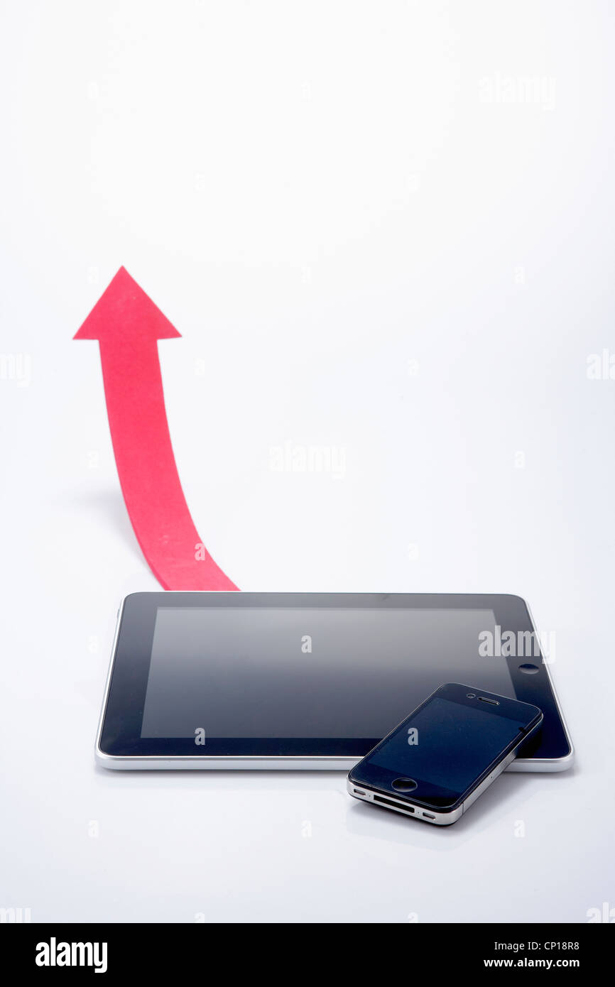 A tablet PC and smart phone with rising arrow Stock Photo - Alamy