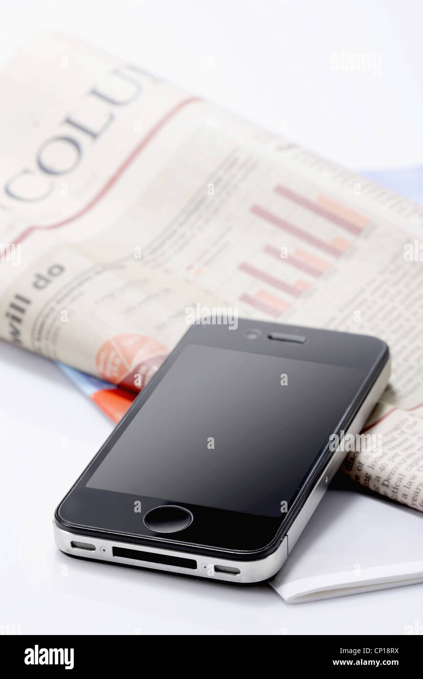 A smart phone and the newspaper Stock Photo - Alamy