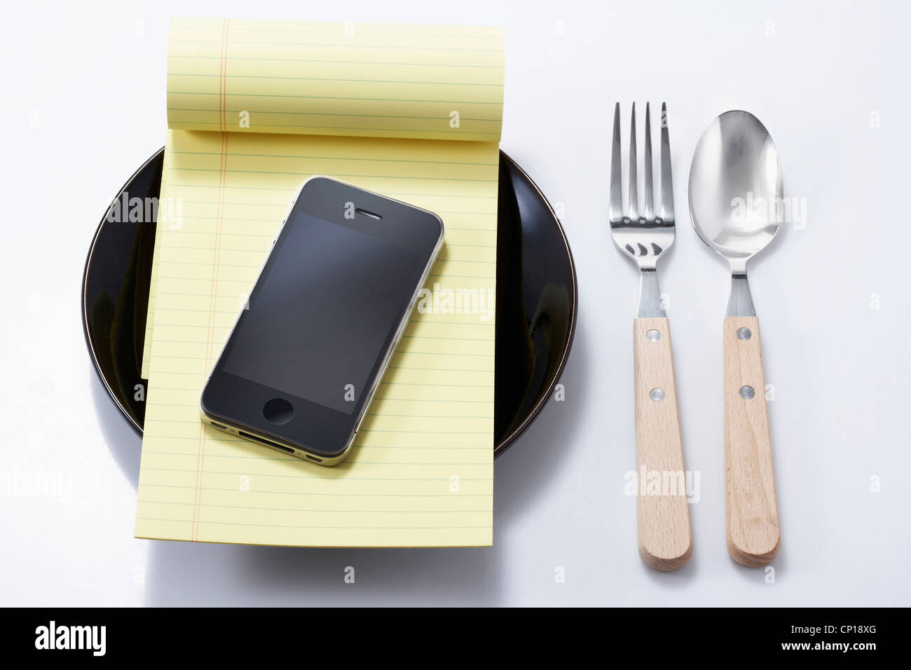 A smart phone and note on the dish Stock Photo - Alamy