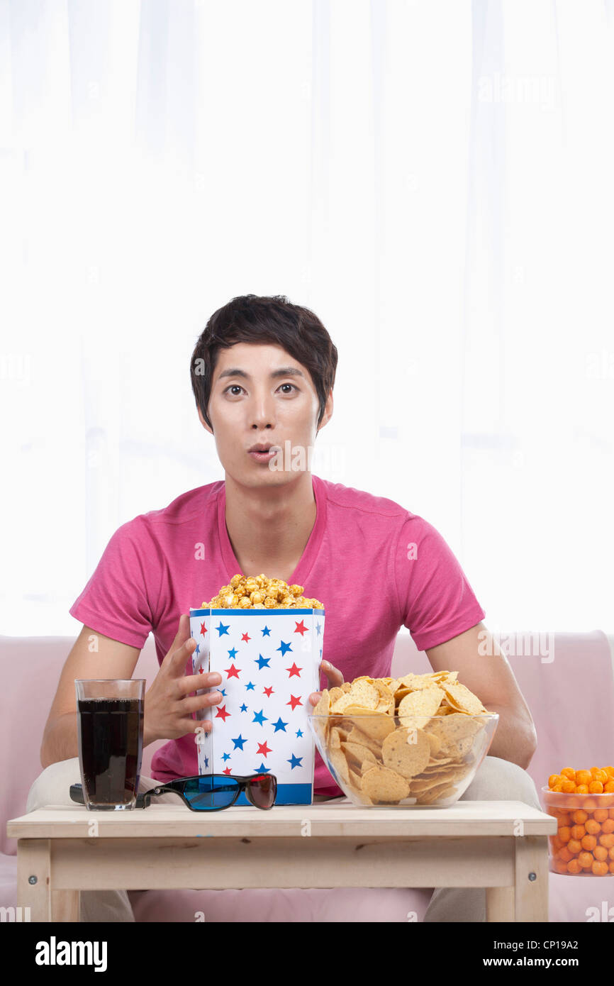 A man watching the movie with pop corn Stock Photo - Alamy