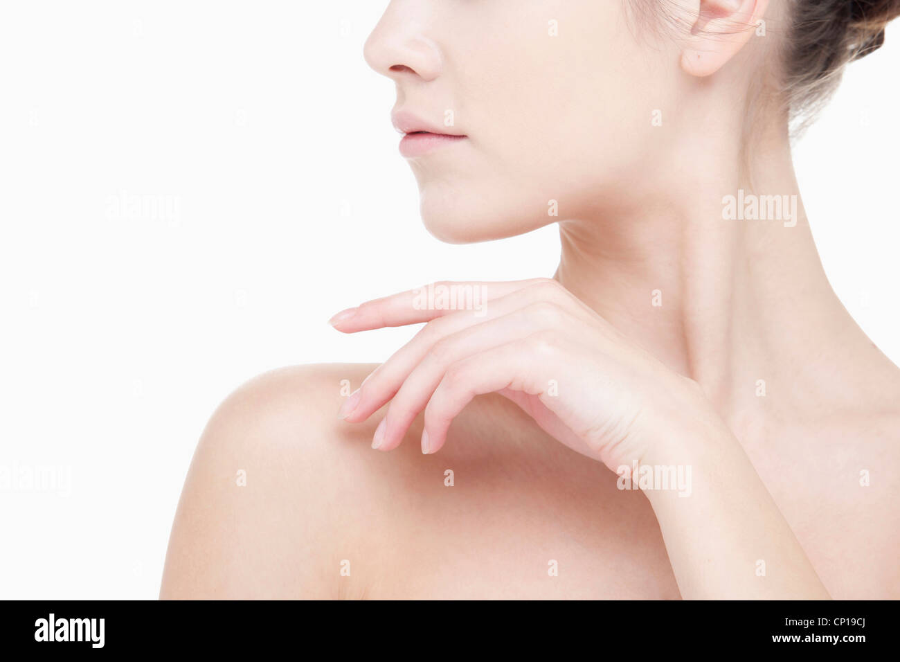 A woman touching her shoulder Stock Photo - Alamy