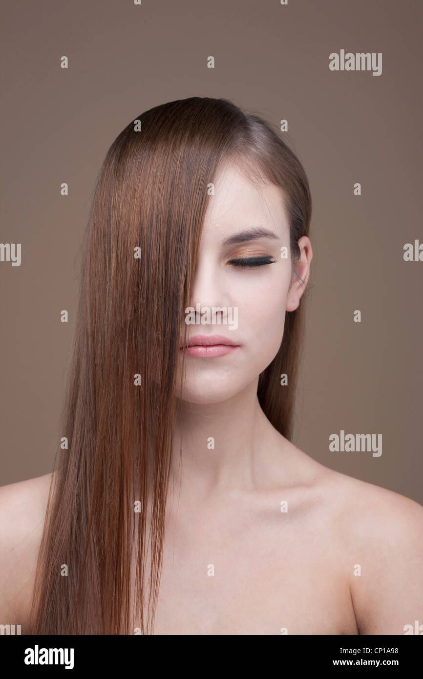 A woman covering her face with hair Stock Photo - Alamy