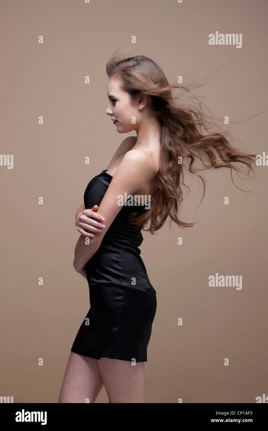A woman with wind-blown curling hair Stock Photo - Alamy