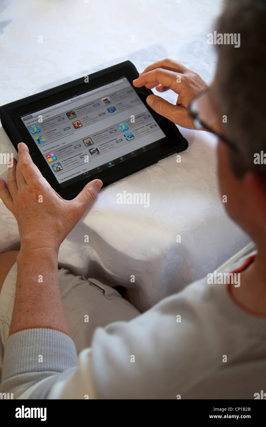 Man browsing Ipad Apps Stock Photo - Alamy