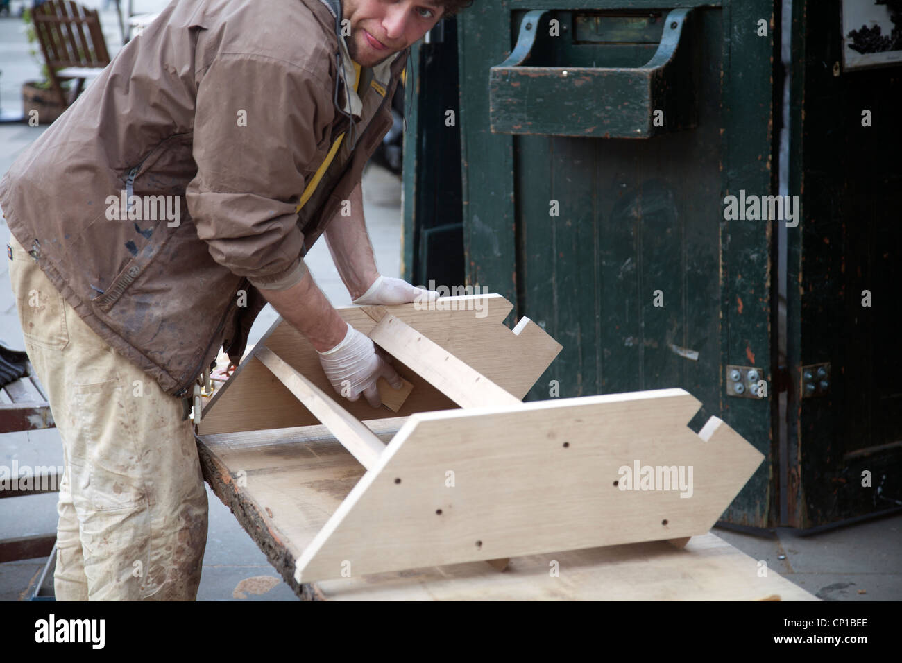 Man sanding wood at Richmond Boatyard Stock Photo - Alamy