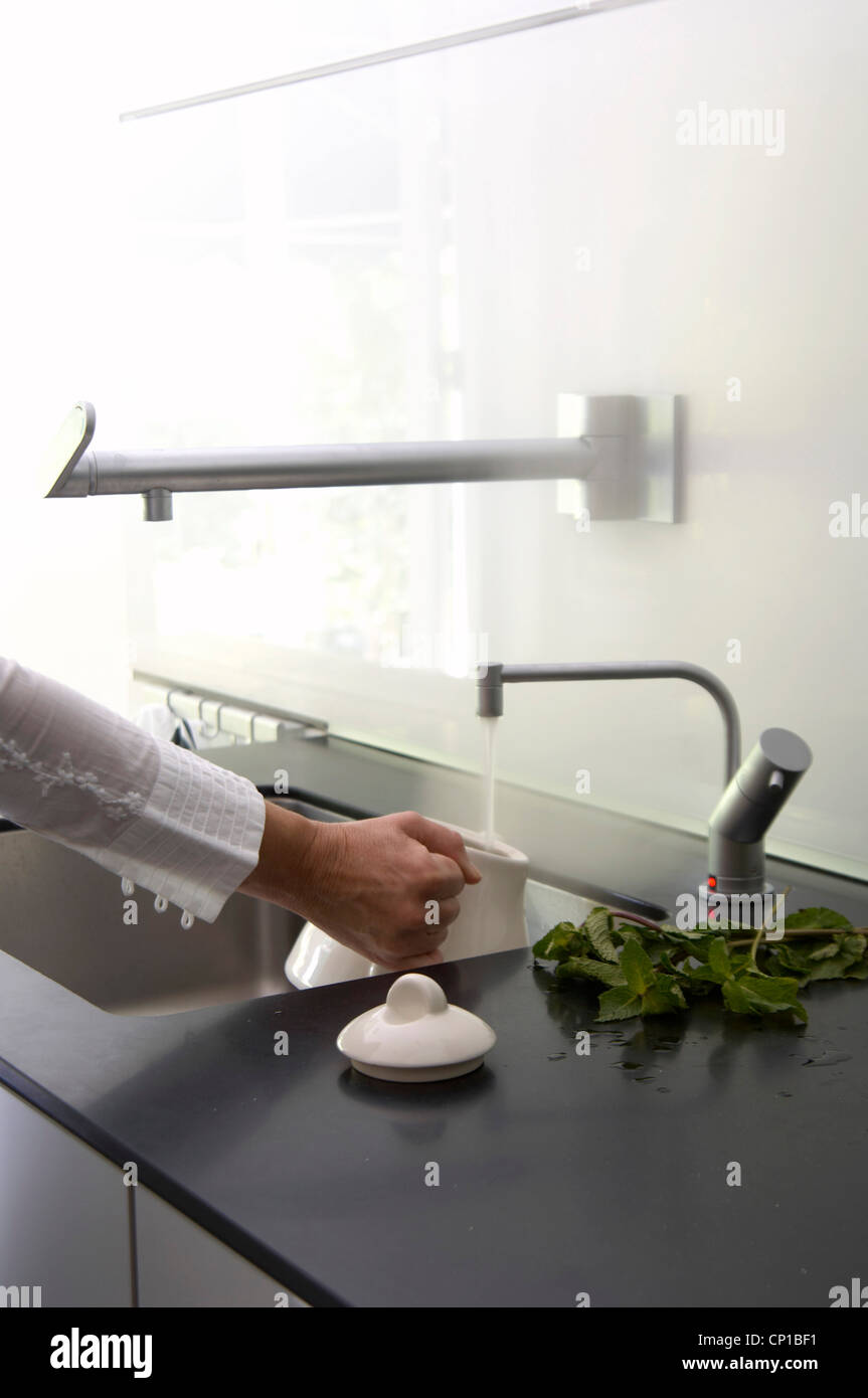 Hand filling jug at tap, Rijswijk, Holland Stock Photo - Alamy
