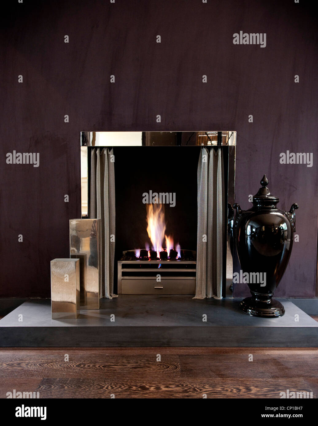 Lit fire with black urn, Addison Road, UK Stock Photo - Alamy