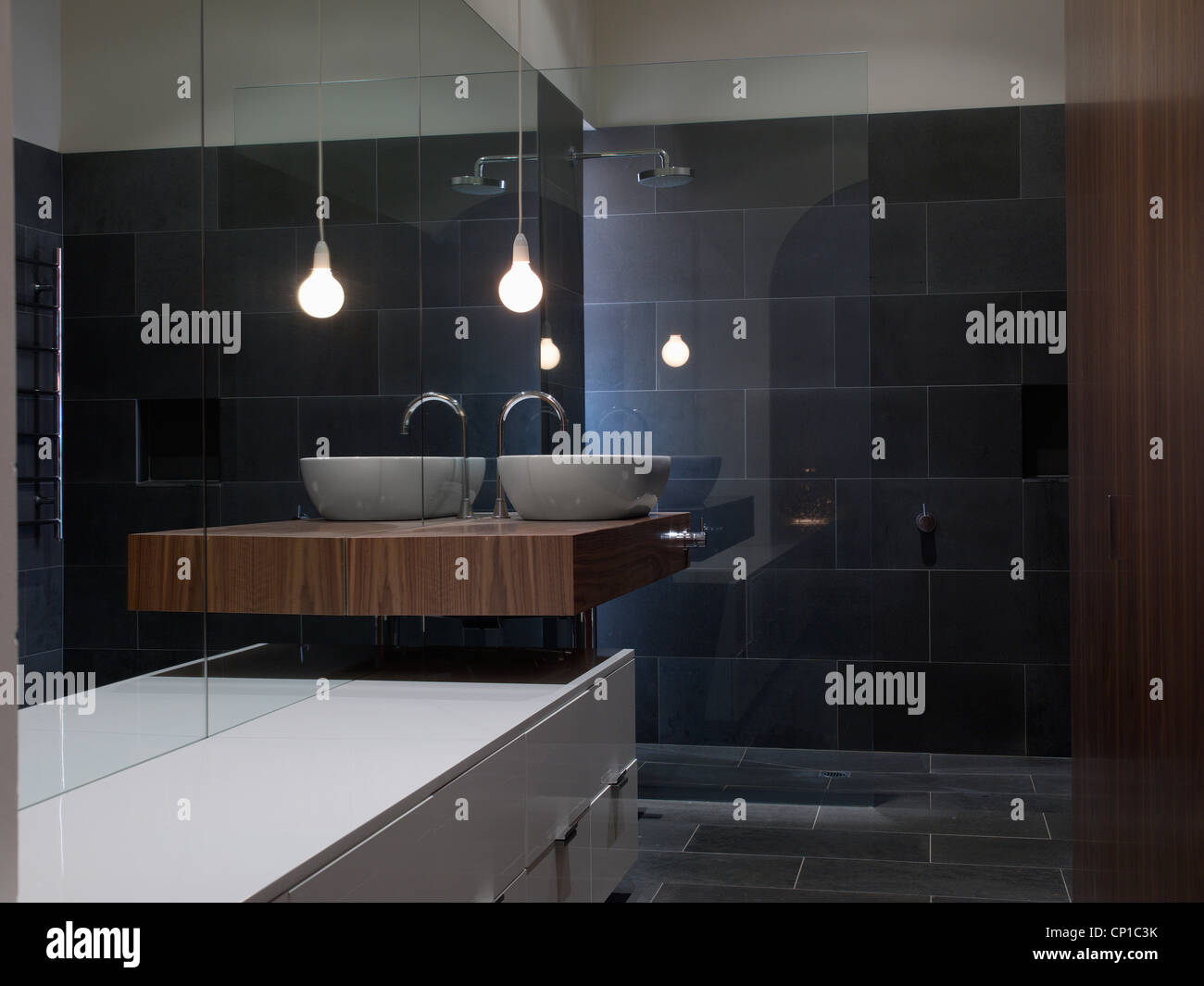 Lightbulb hangs over basin in bathroom of Melbourne home, Victoria ...