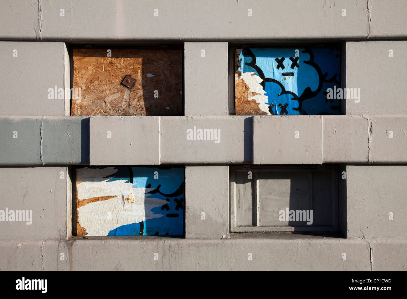 Boarded windows and fly posters Stock Photo - Alamy