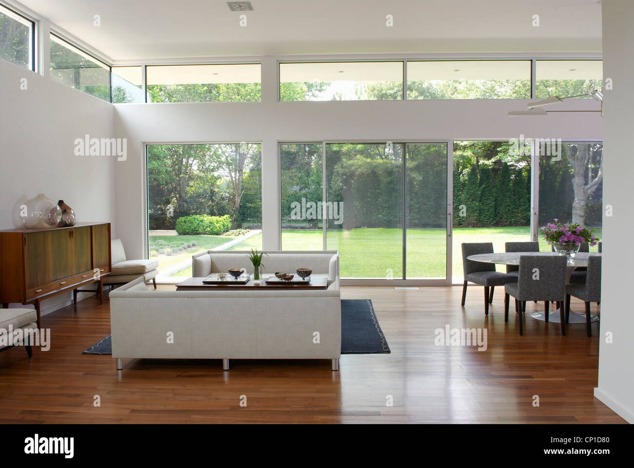 Pair of sofas and dining table and chairs in spacious open plan sitting ...